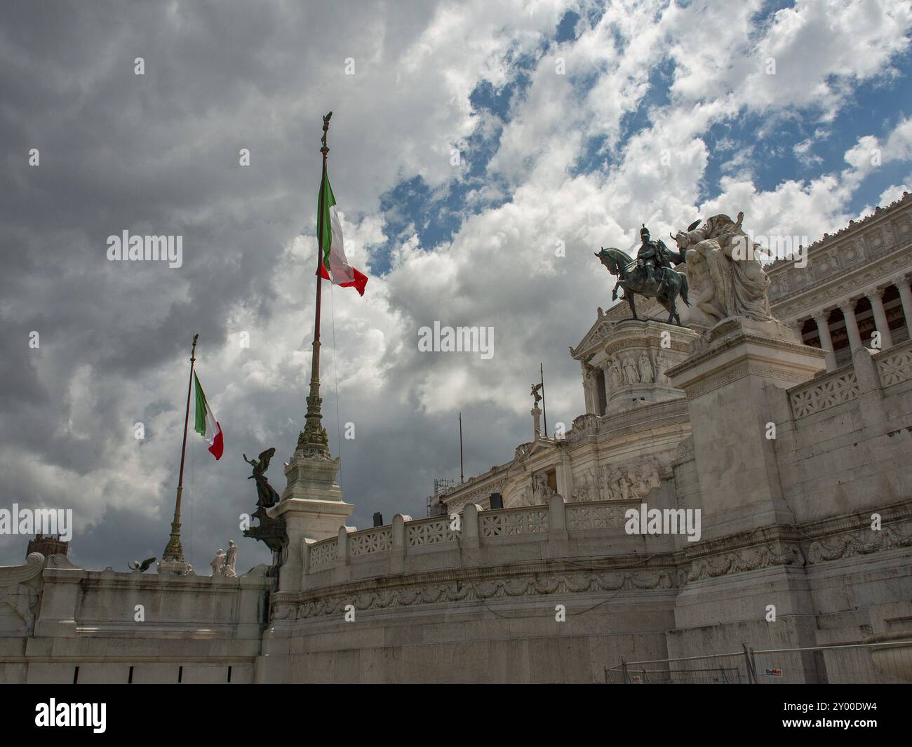 Italian flags waving on a monument with sculptures in Rome under a ...