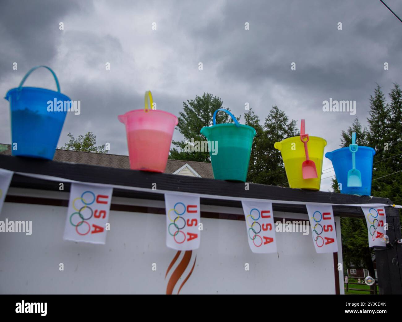Colored pails on a fence at a ice cream store Stock Photo - Alamy