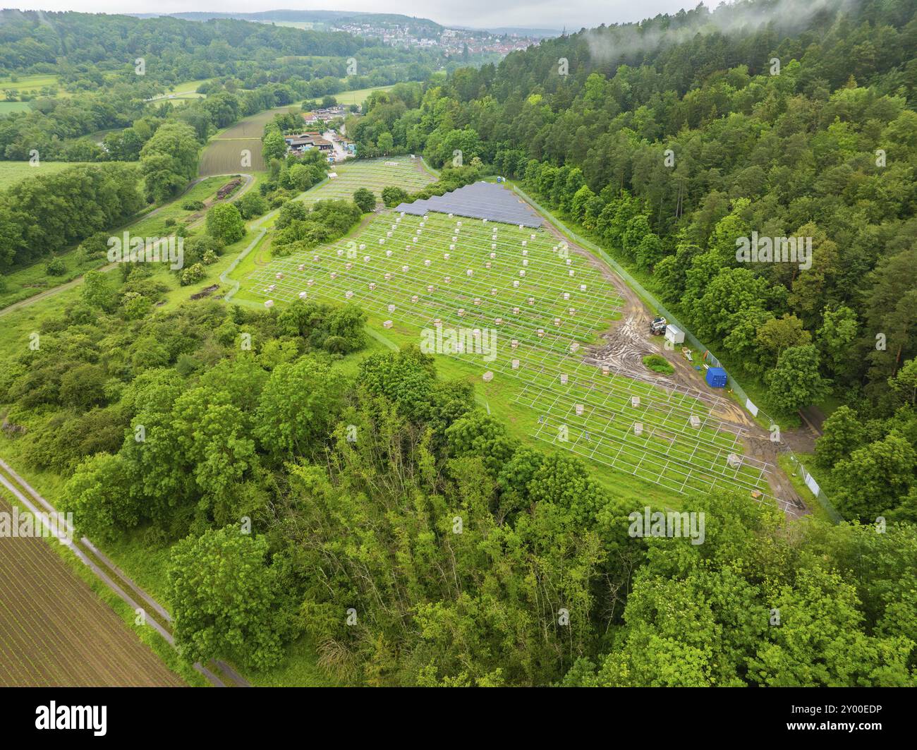 Aerial view of solar installations in a green landscape, surrounded by ...