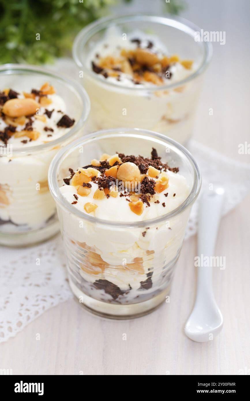 From above of dessert portions with white cream and crushed toppings ...