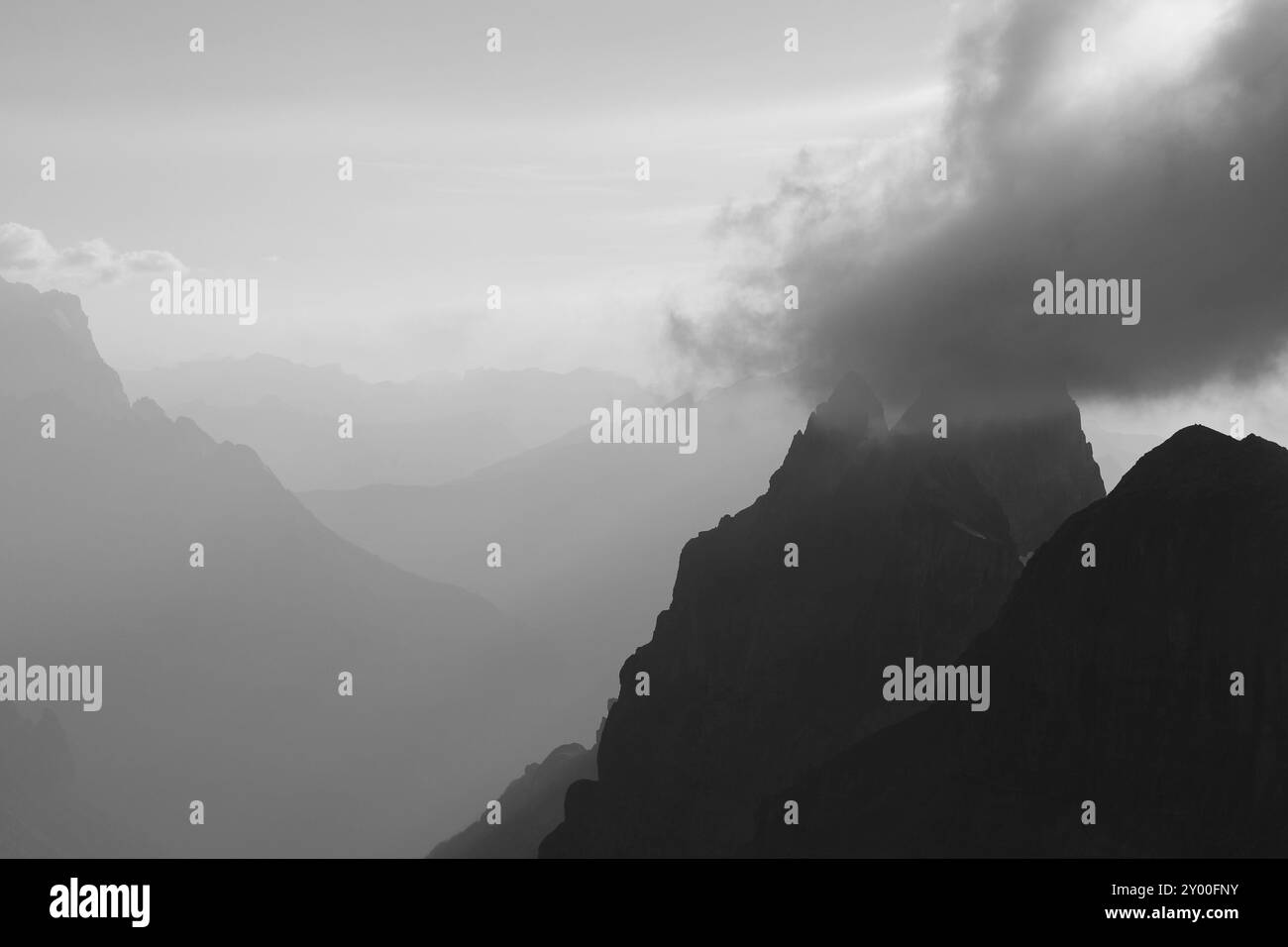 Cloud over a mountain peak. Summer evening in the Swiss Alps, view from ...