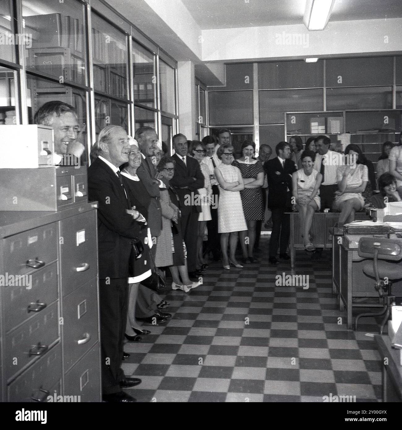 1960s, historical, smiles and laughter as a company's employees gather ...