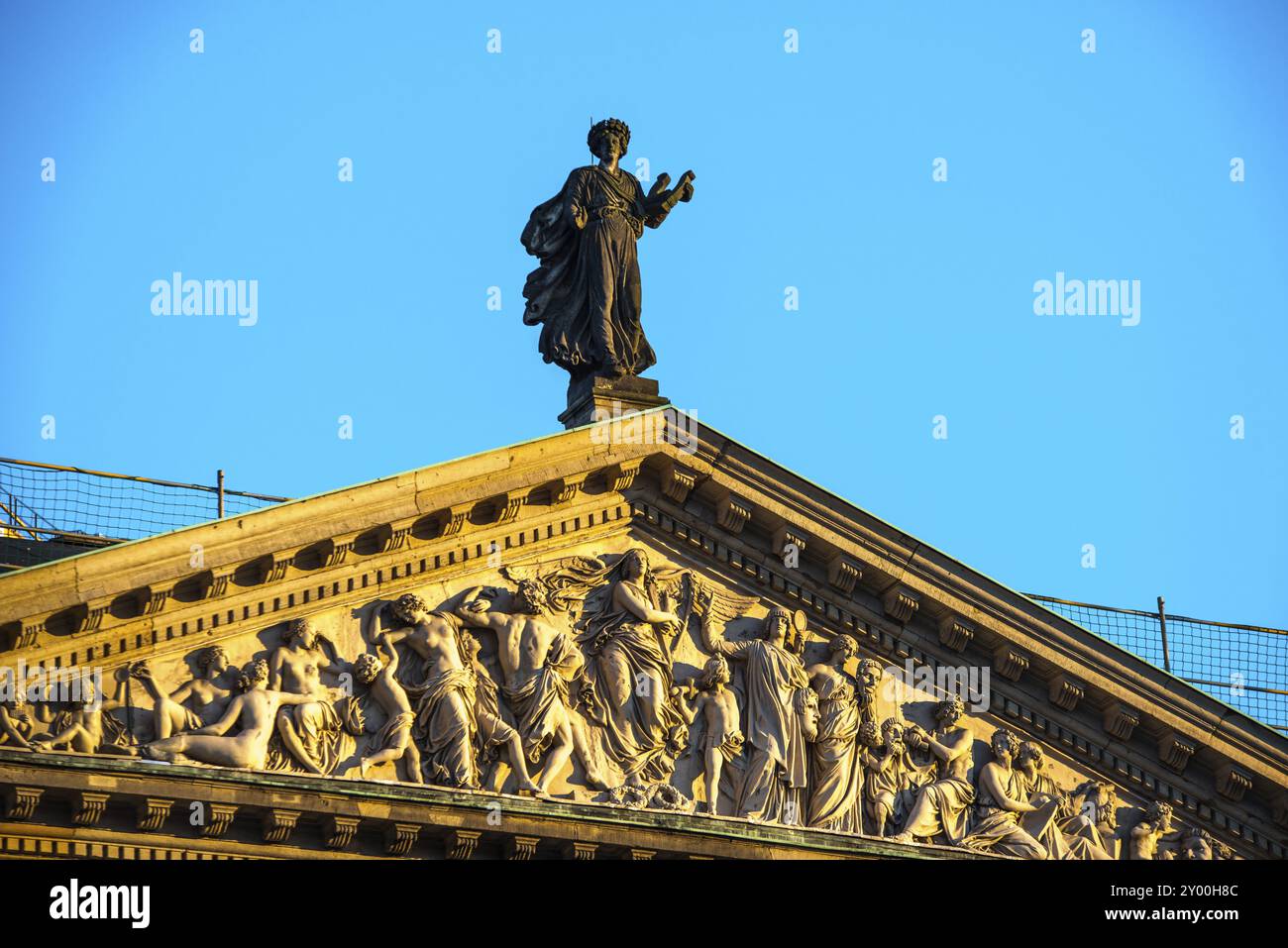 Blackened statue on a sandstone pediment with relief Stock Photo - Alamy