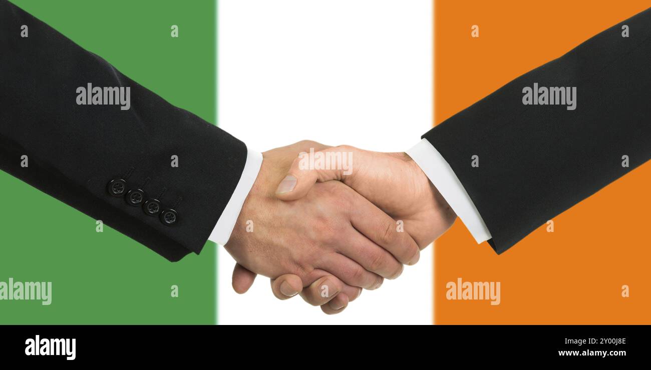 The irish flag and business handshake Stock Photo - Alamy