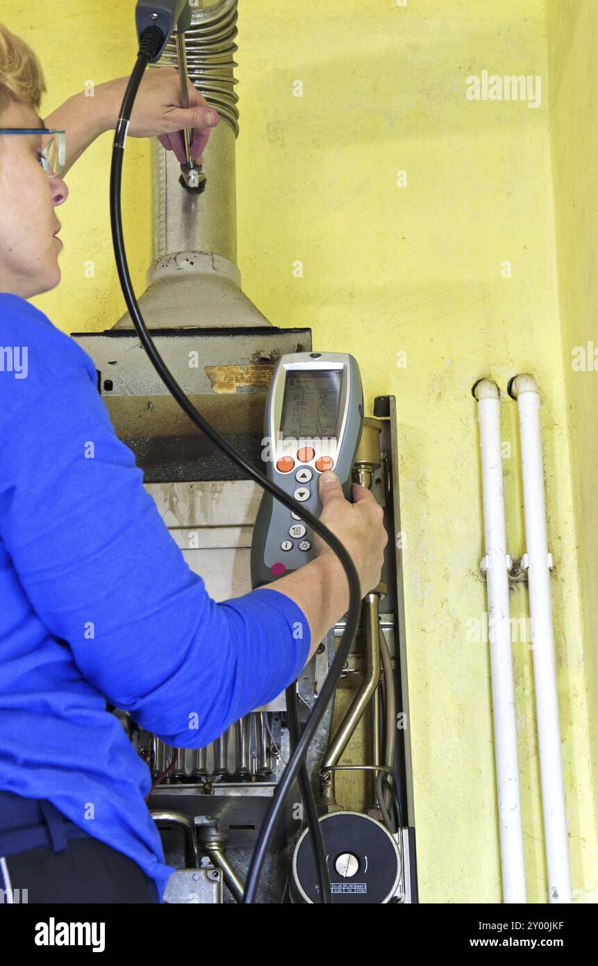 Plumber measuring the flue gas at a gas heating Stock Photo - Alamy