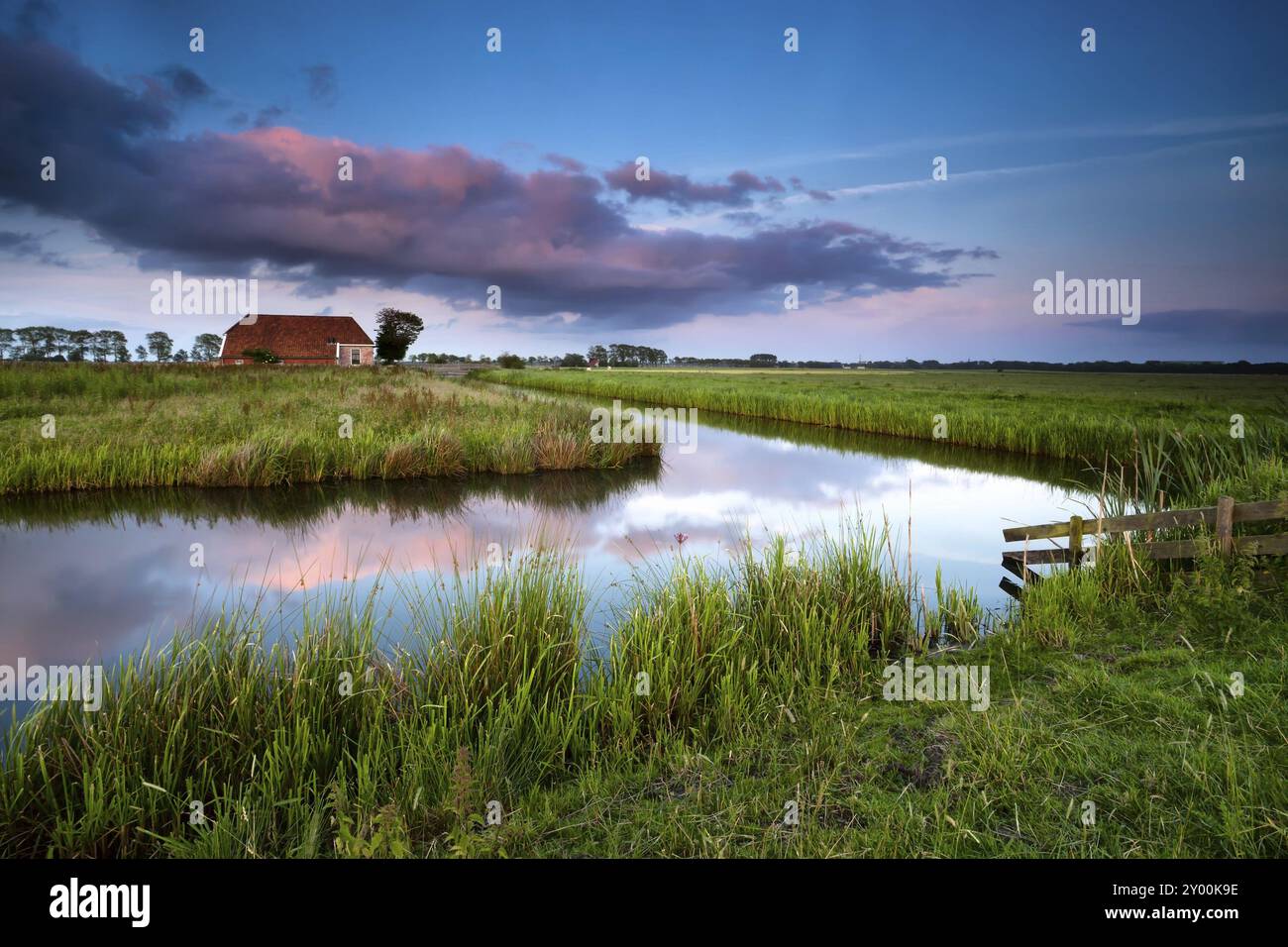 Little farmhouse and river at colorful sunset, Groningen, Netherlands ...