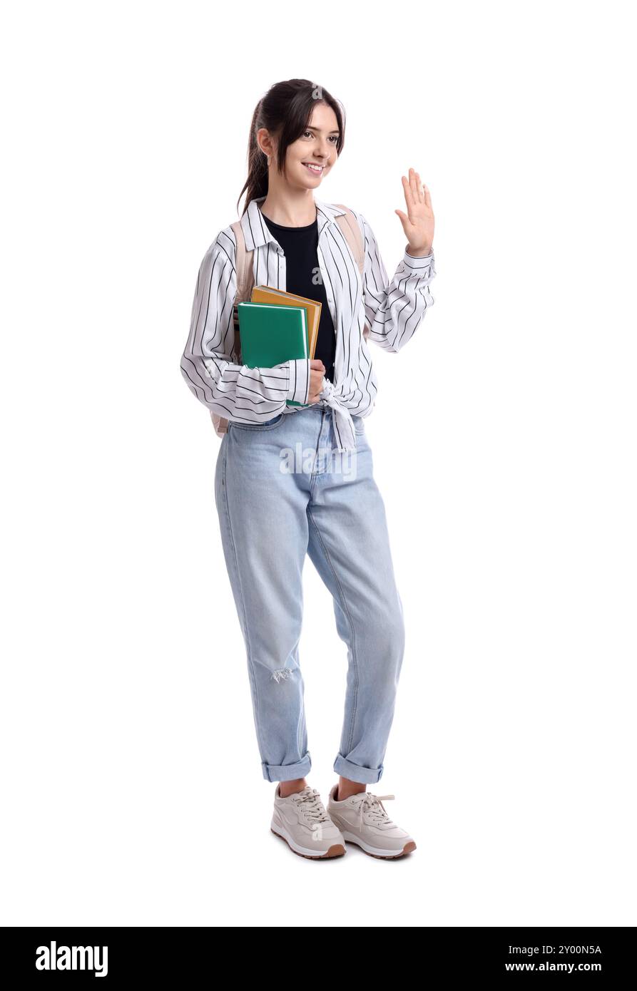 Teenage girl with books waving hello on white background Stock Photo ...