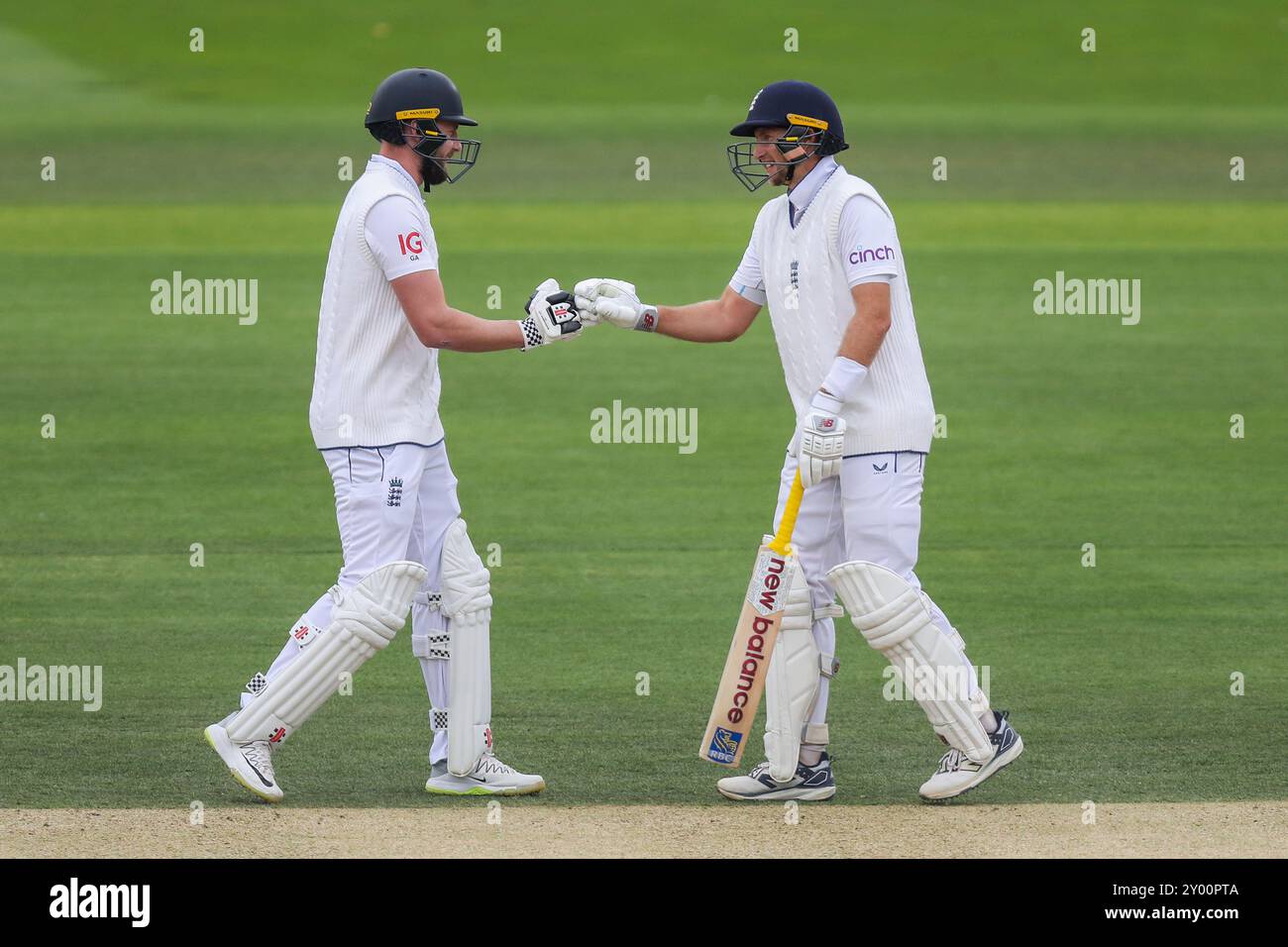 Gus Atkinson and Joe Root of England celebrate four runs during England ...