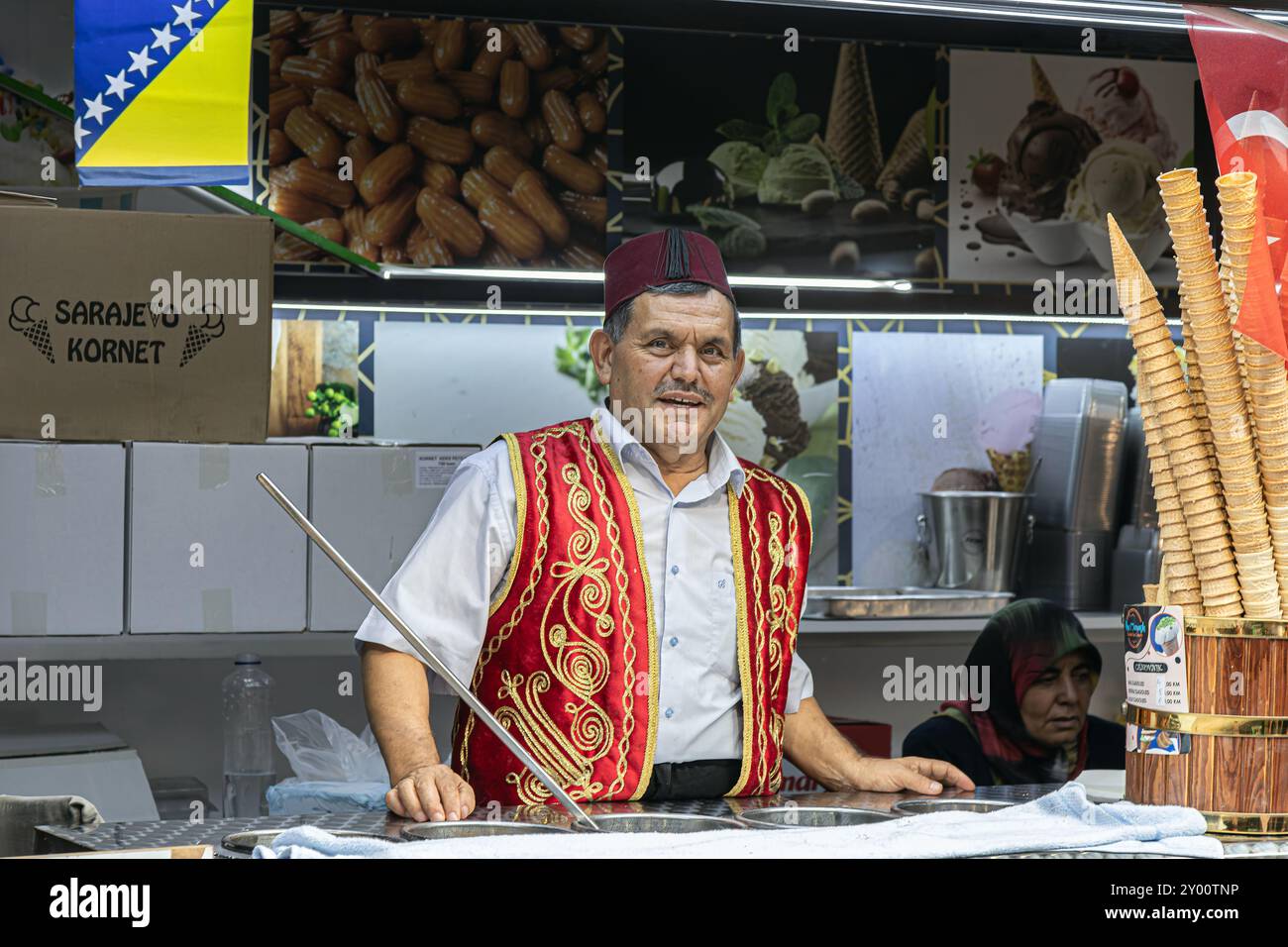 SARAJEVO, BOSNIA AND HERZEGOVINA - AUGUST 24, 2024: Smiling man selling ...