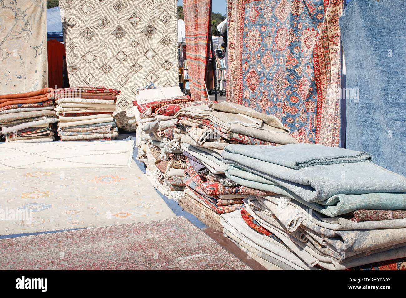 A view of several Persian throw rugs, on display at a local swap meet ...