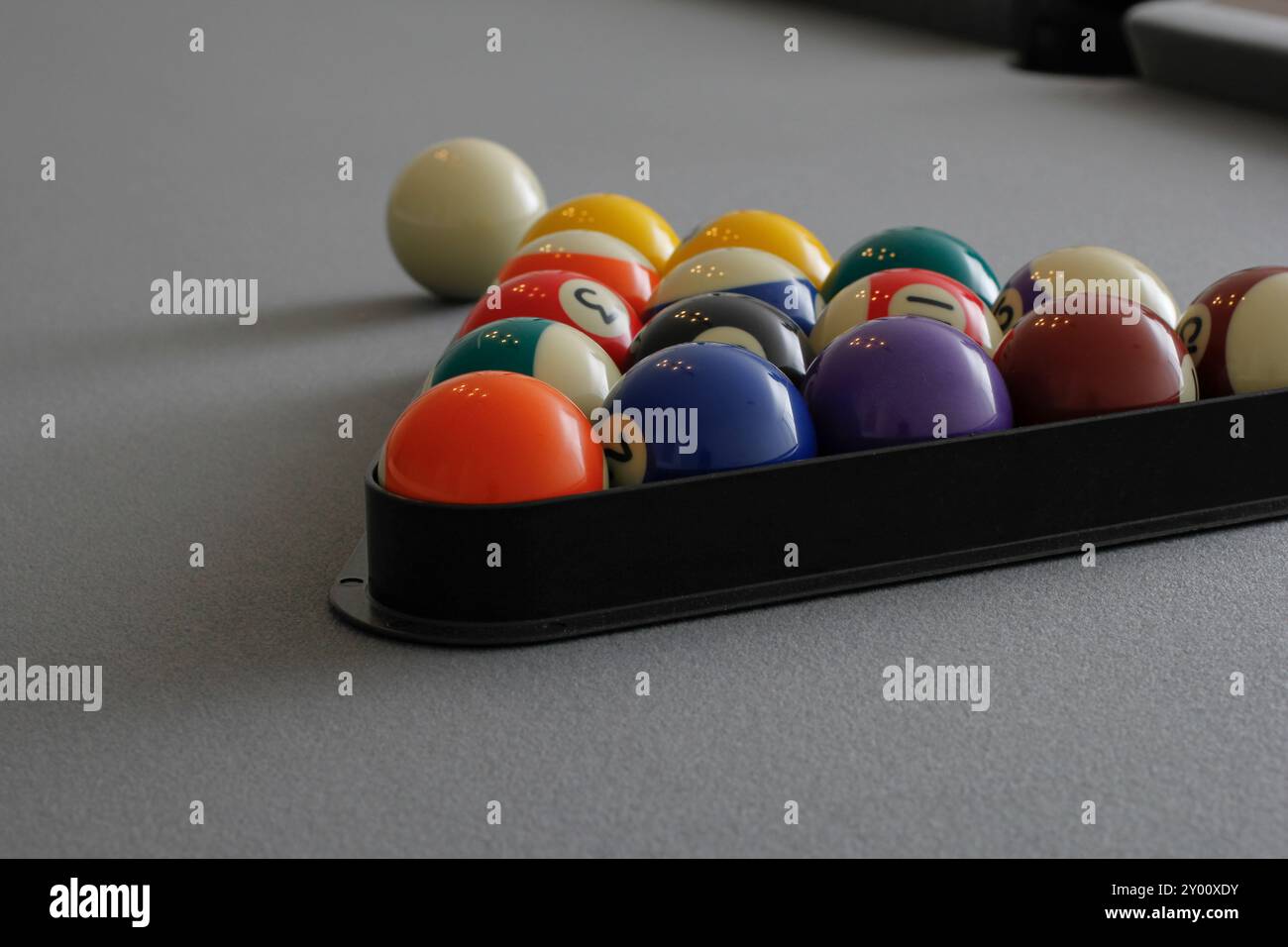 A view of a set of pool balls organized inside a triangle rack on a ...