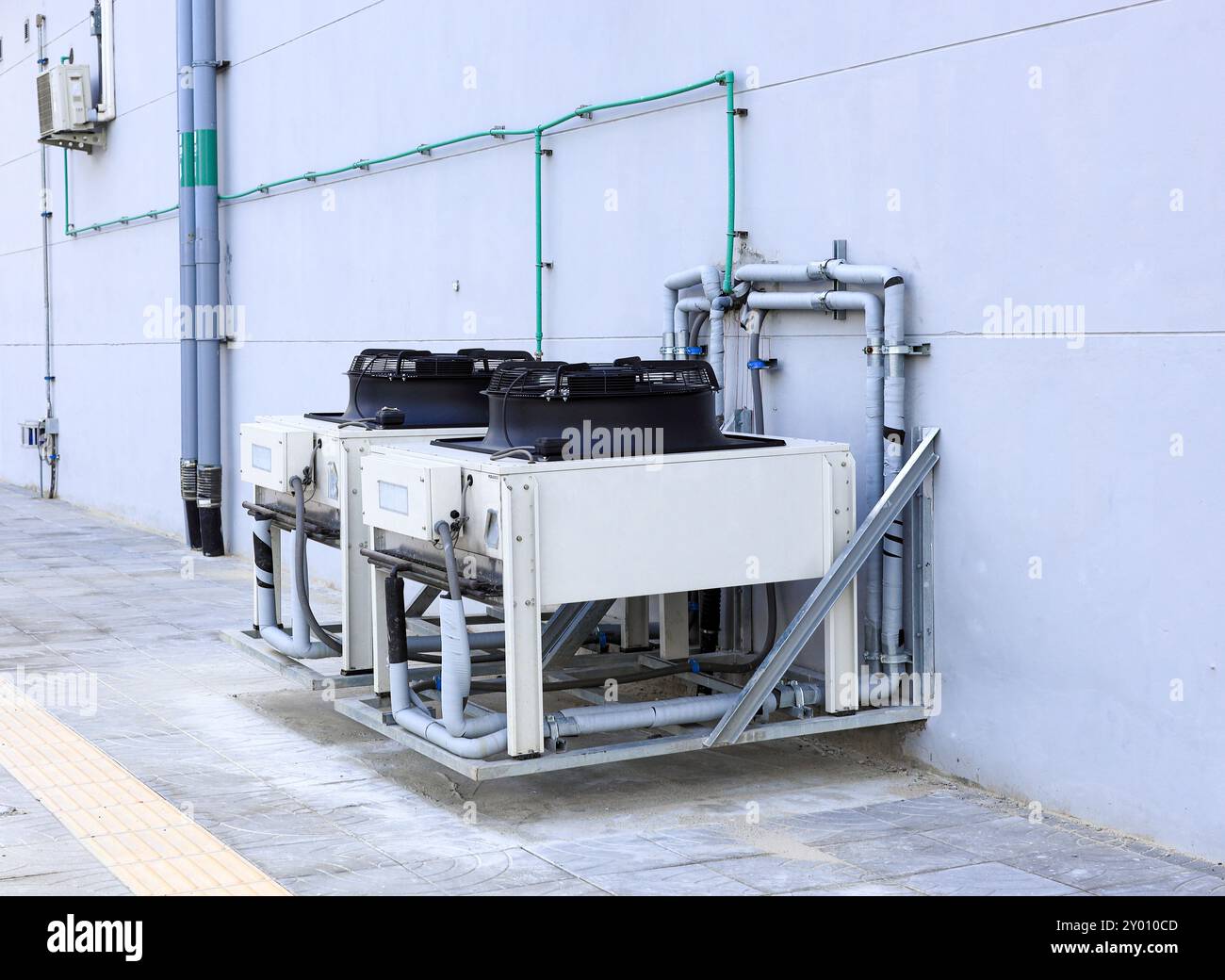 Condensing units of air conditioning systems, Condensing unit installed on the wall. Outdoor air ...