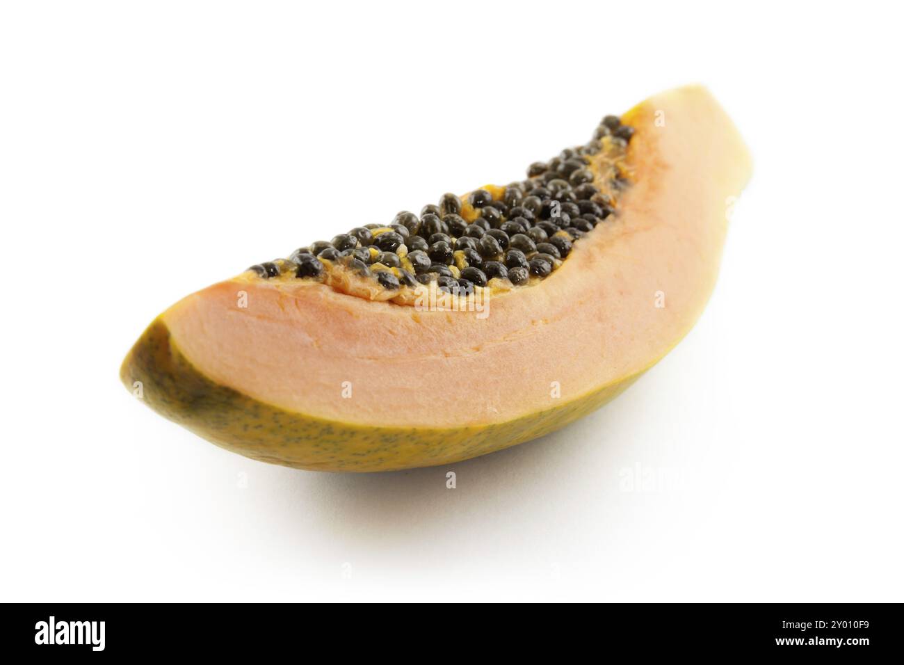A cut papaya fruit, a cut papaya fruit in front of white background ...