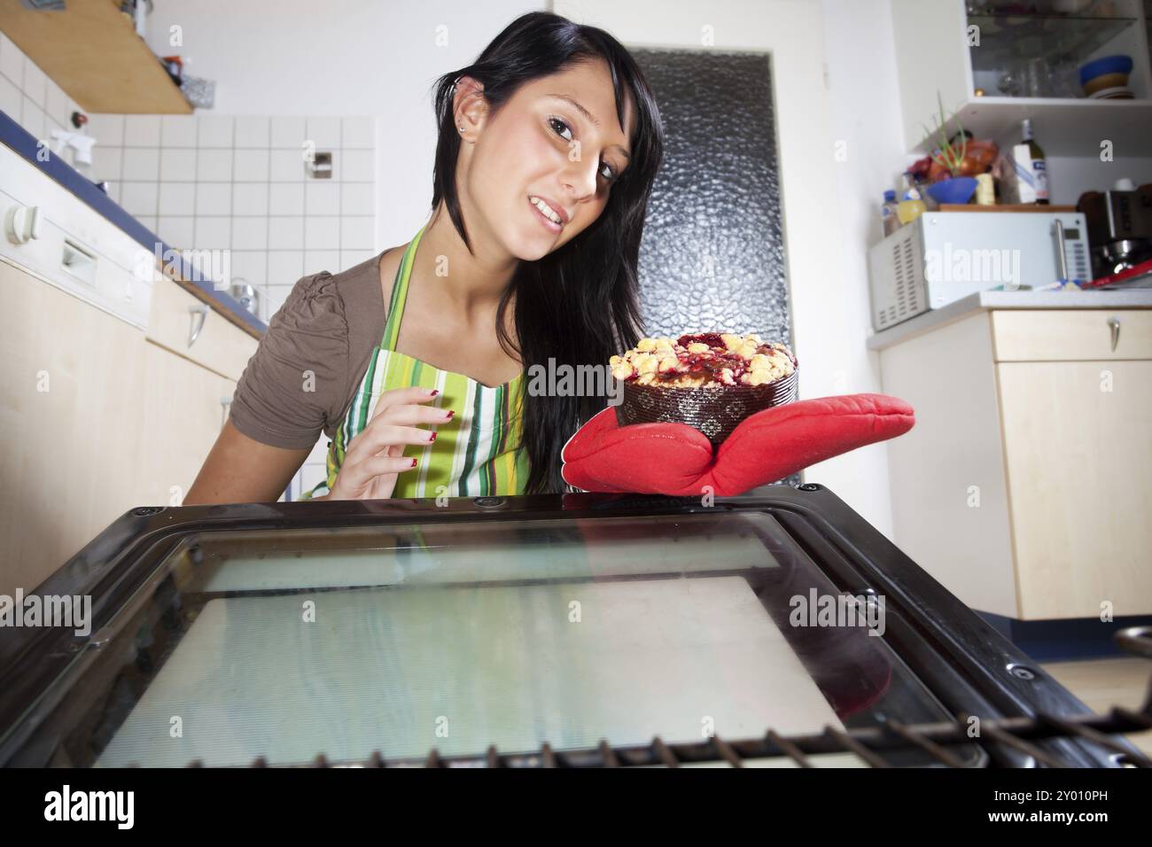 Woman takes cake out oven hi-res stock photography and images - Alamy