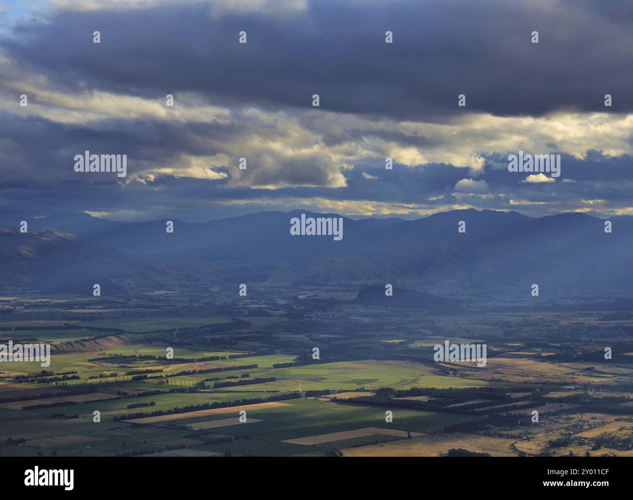 Rural landscape on the South Island. Sunlight breaking trough clouds ...
