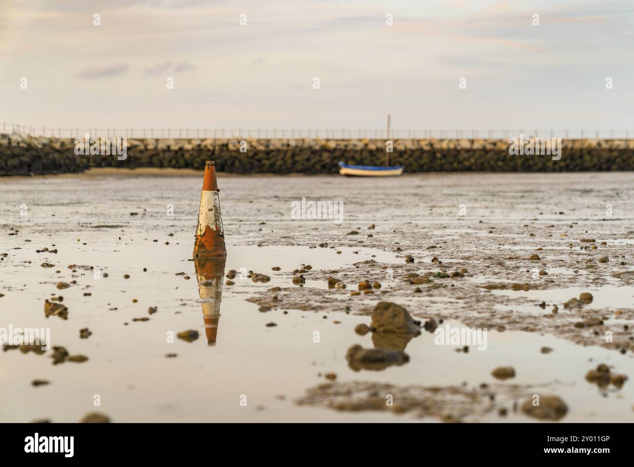 A pylon in the mud and a boats at low tide near Neptunes Arm in Herne ...