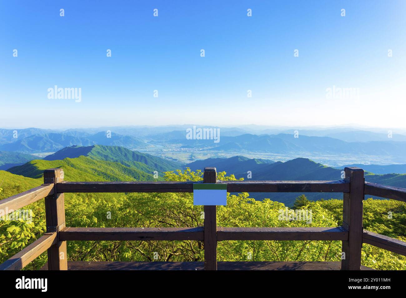Wooden viewpoint deck offering clear view of valley below from atop ...