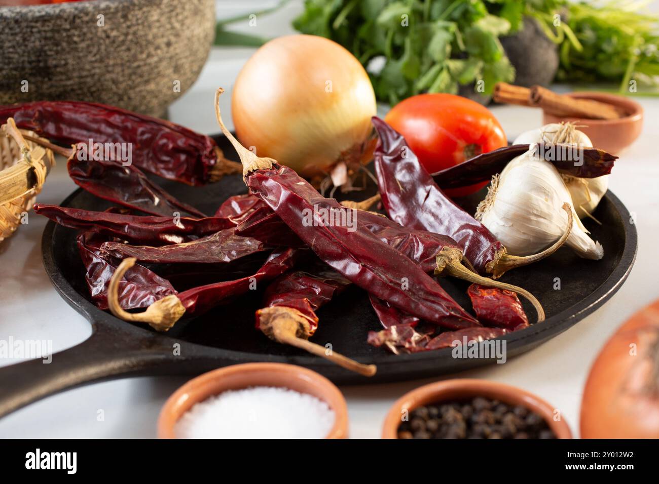 A view of dried guajillo chiles on a comal, among other salsa ...