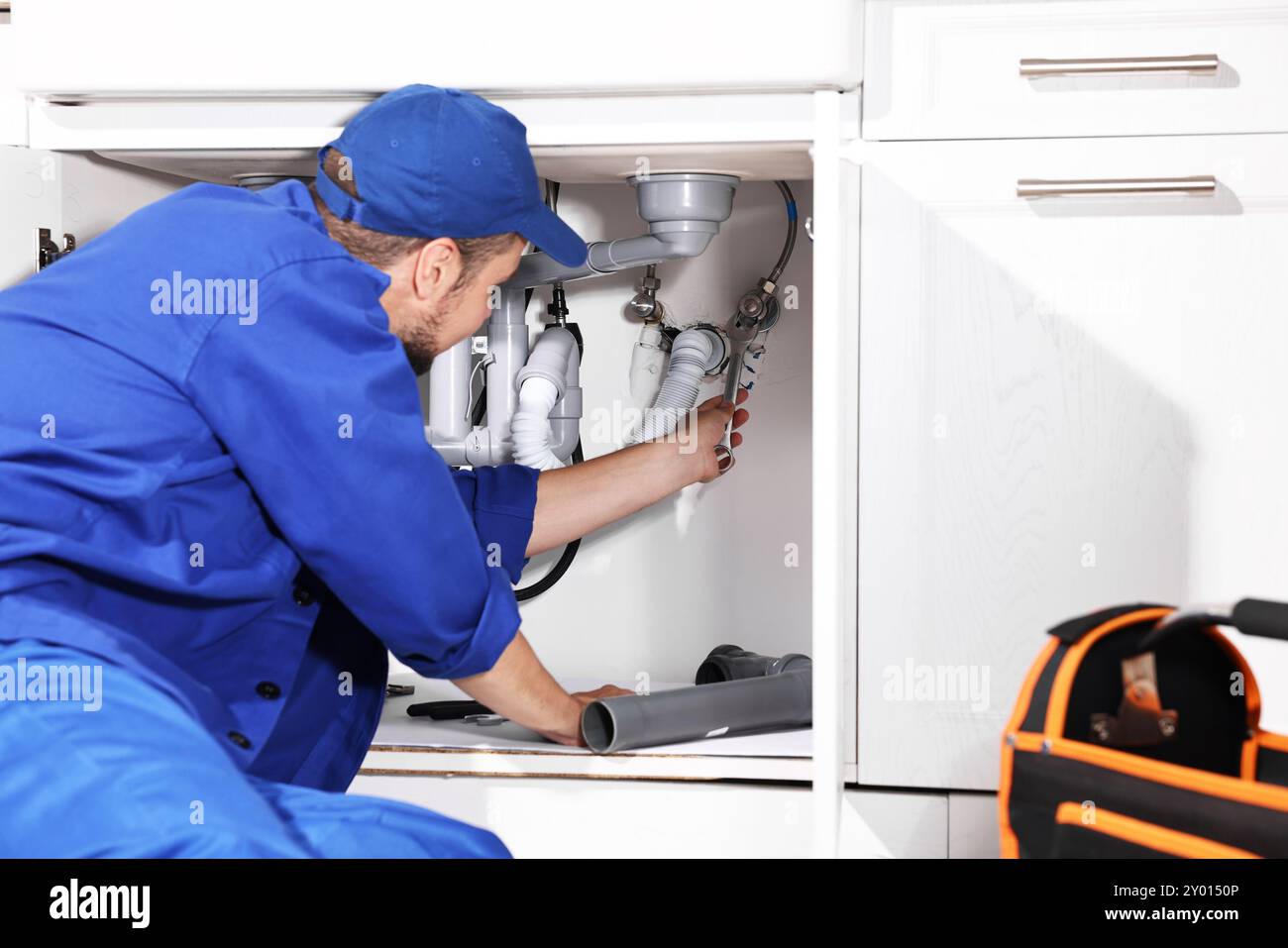 Professional plumber fixing piping system at home Stock Photo - Alamy