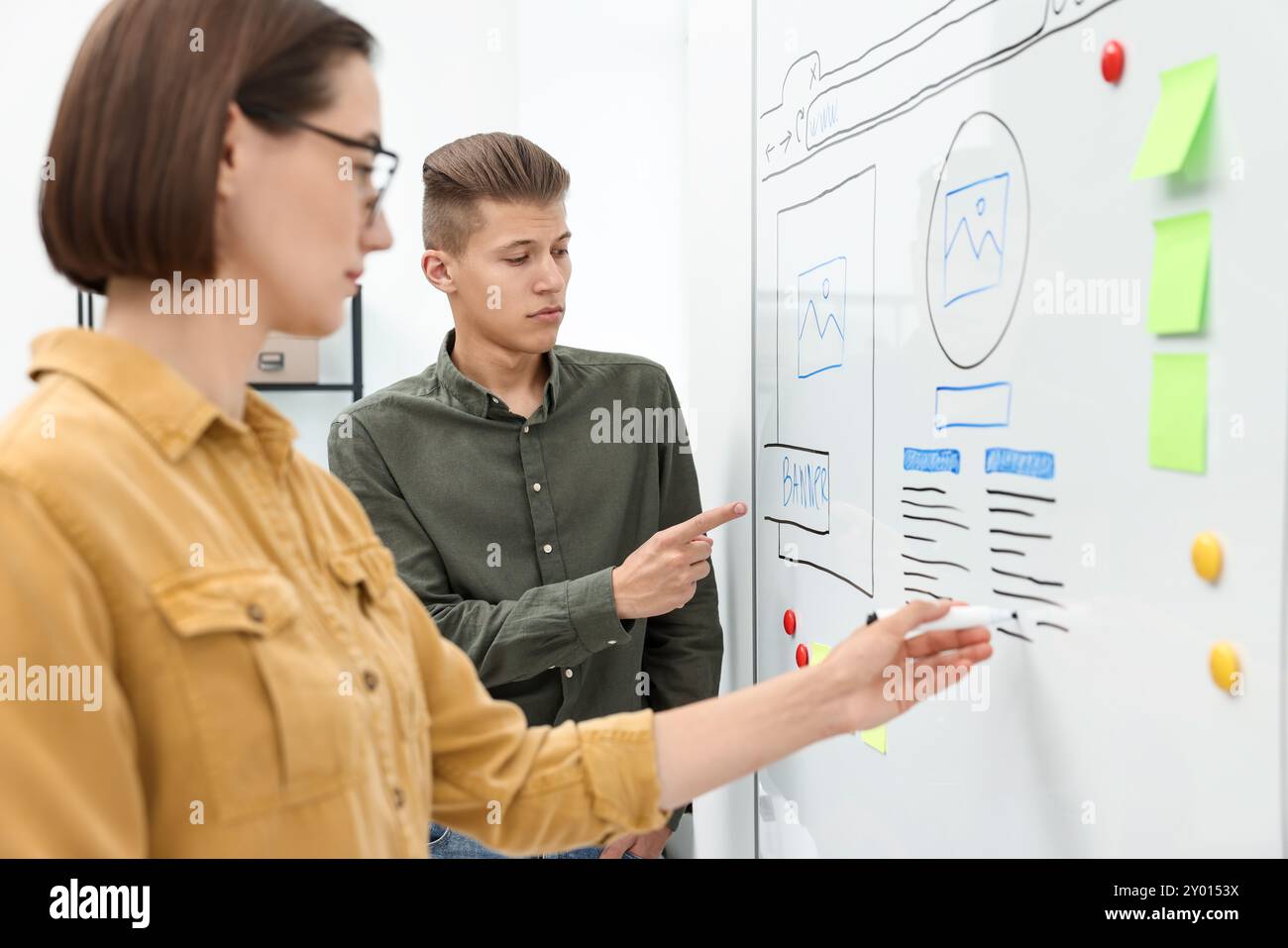 Developing UI design. Man and woman drawing website wireframe on ...