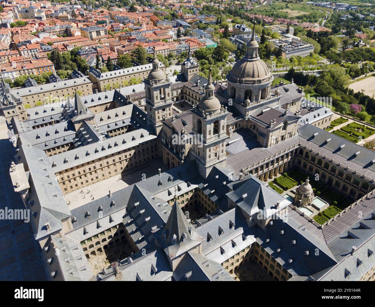 Aerial view of a historic monastery with towers and nearby town ...