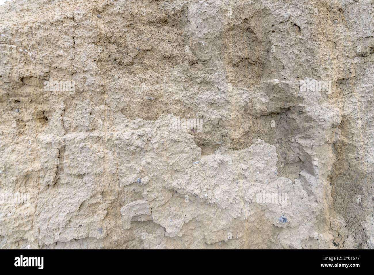 Sand wall made of light-coloured sand with small pebbles as a ...