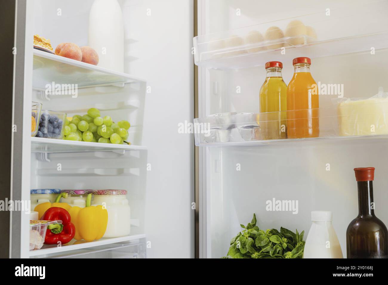 Front View of open two door fridge or refrigerator door filled with ...