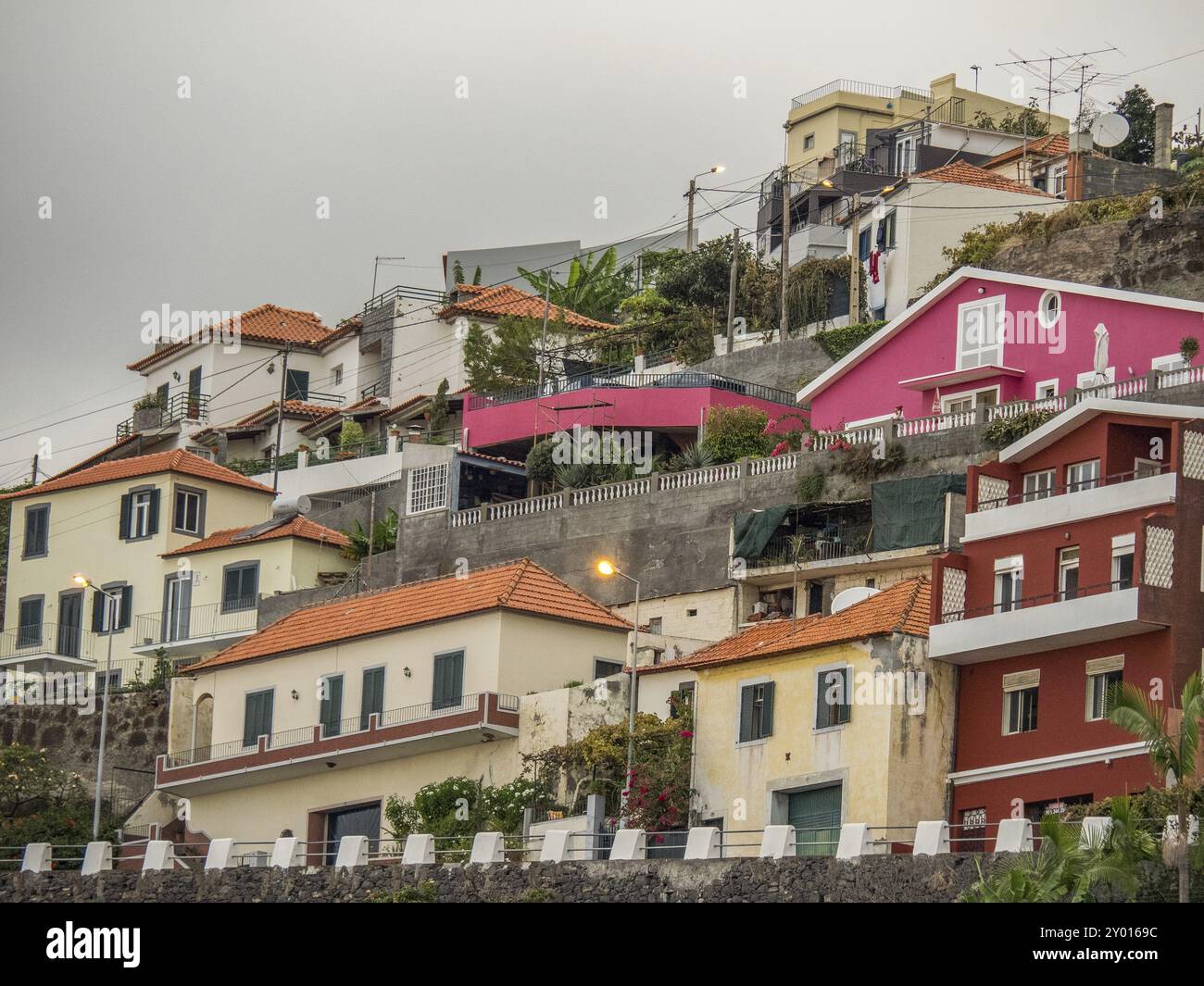 Colourful houses stretching along the hillside of an urban landscape ...