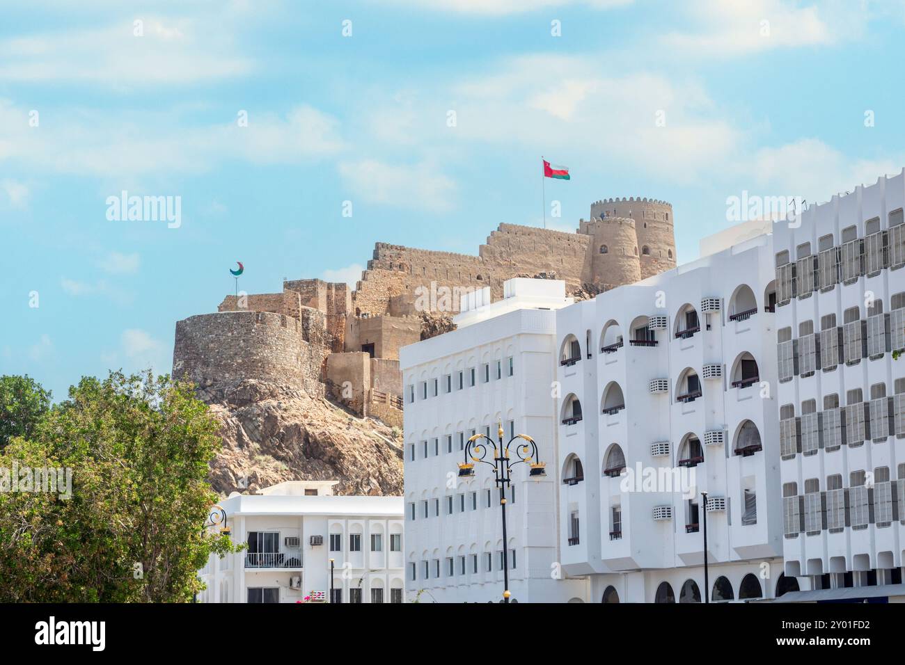 Mutrah castle on the hill with waving omani flag on top, Muscat ...