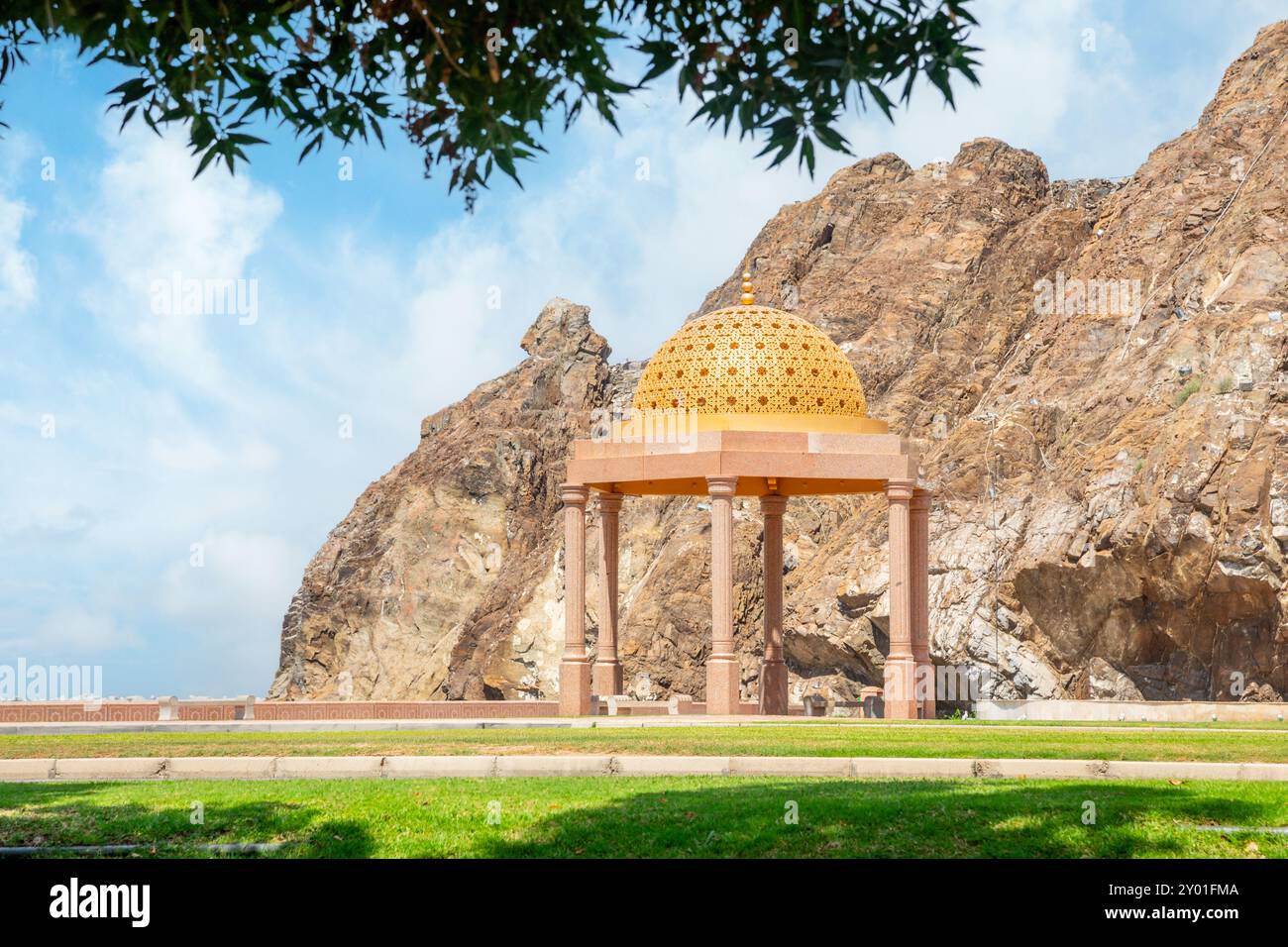 Golden ornated dome gazebo in traditional Omani style with rocks in the ...