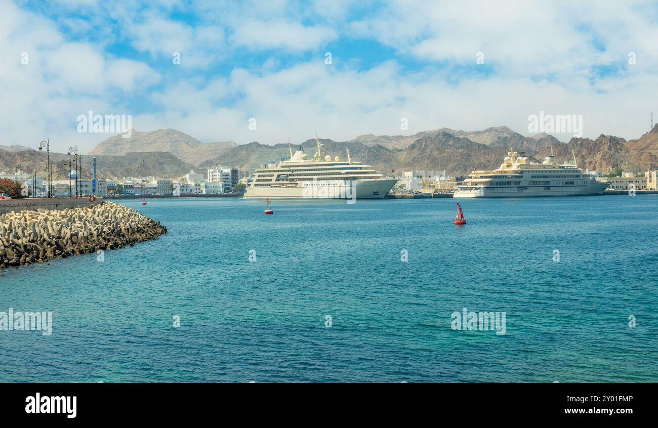 Mutrah promenade panorama with mountains and tourist cruise liner ships ...