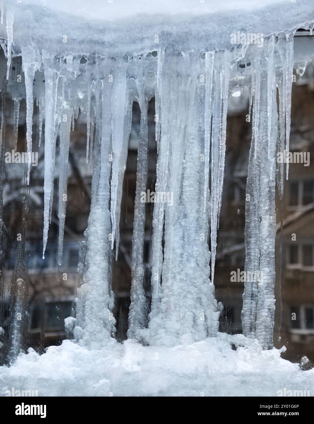 Frozen window with icicle on it. Winter background Stock Photo - Alamy