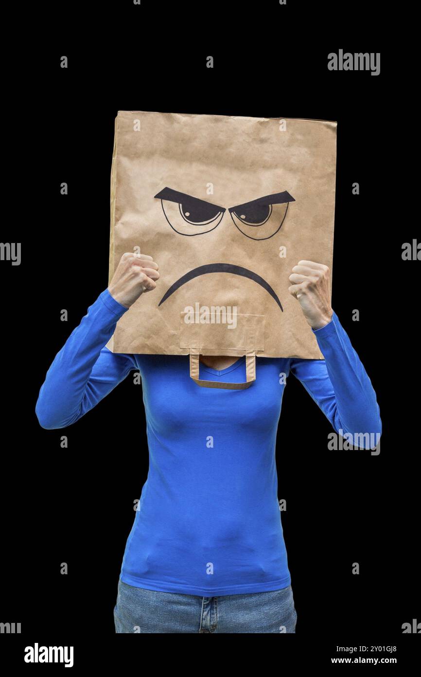 Woman wears paper bag with angry face isolated on black background ...