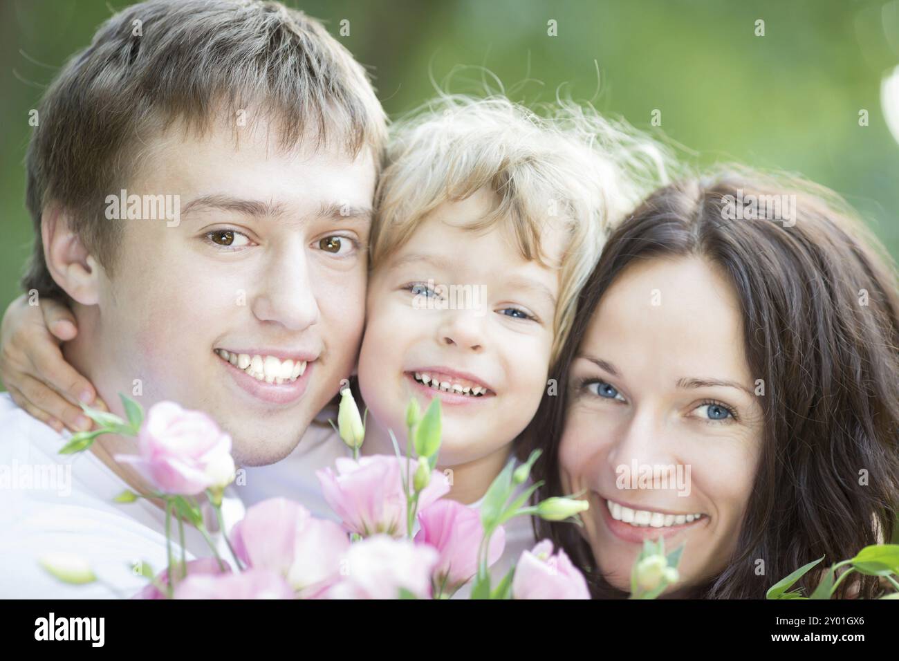 Happy family having fun outdoors in spring park against green ...