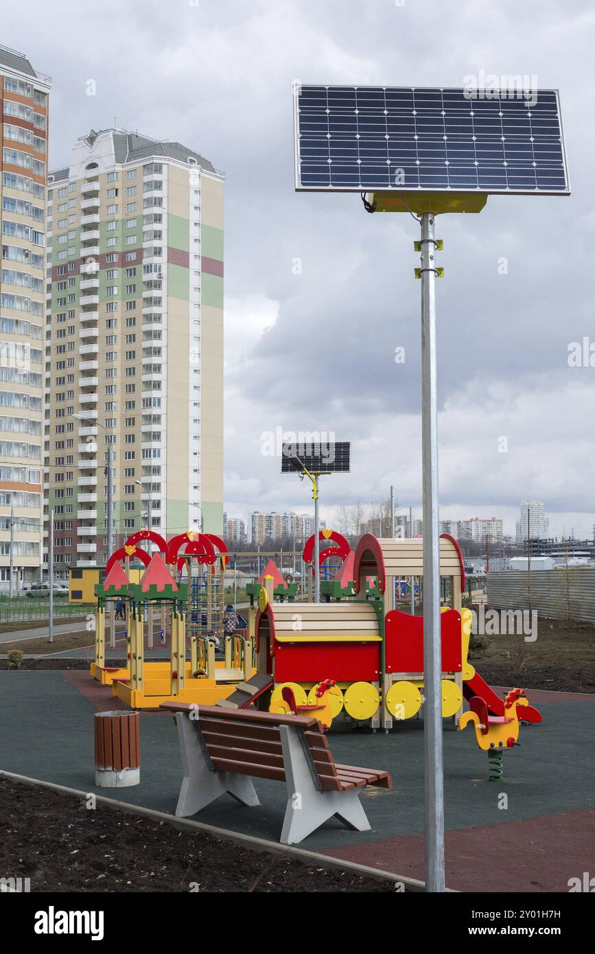 A children's playground in the courtyard of an apartment house with ...