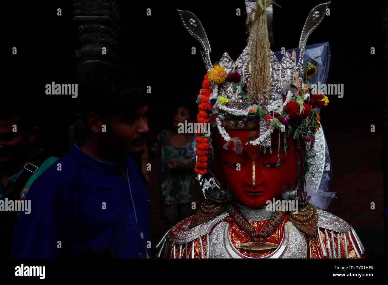 A person concealed inside the idol of Deity Dipankar Buddha receiving ...