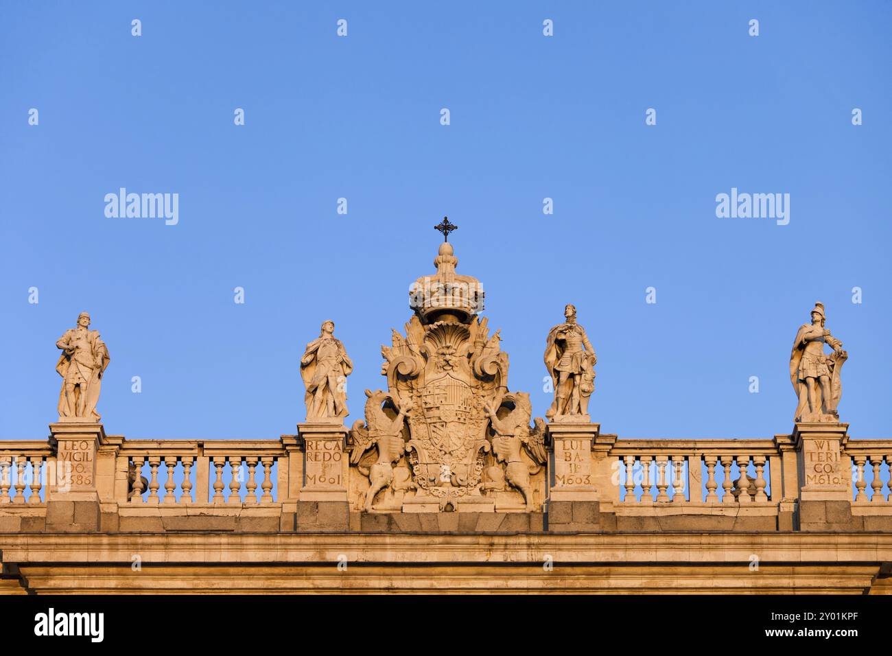 Coat of arms of Spain on top of Royal Palace in Madrid, statues of ...
