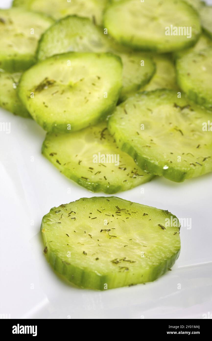 Cucumber salad with dill in a white square plate Stock Photo - Alamy