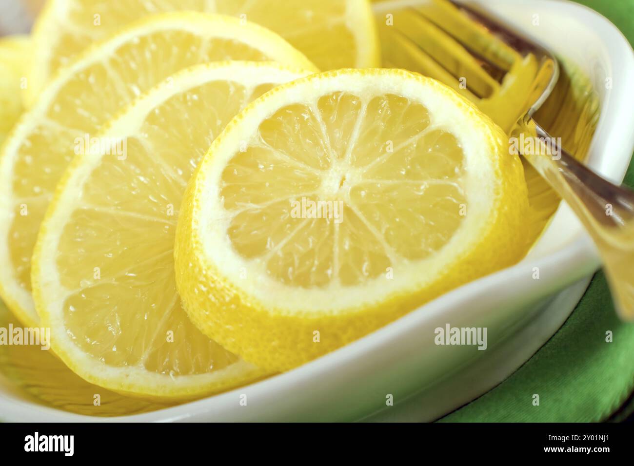 Juicy yellow lemon slices on white dish Stock Photo - Alamy