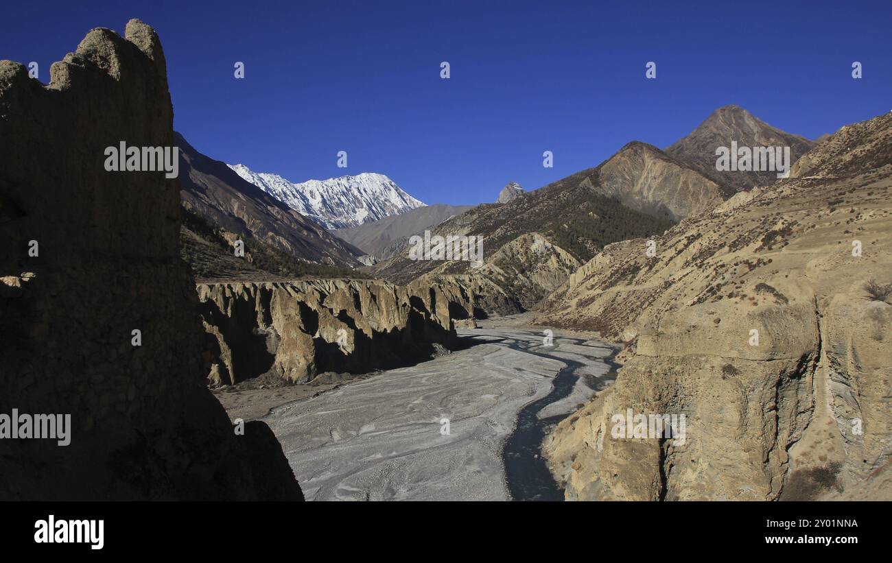 Marsyangdi river and limestone cliffs. Snow capped Tilicho Peak ...
