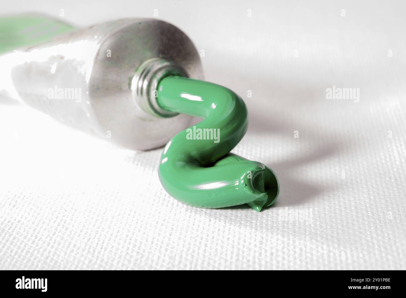 Emerald Green oil paint is pressed from the tube, and squirted on to a ...