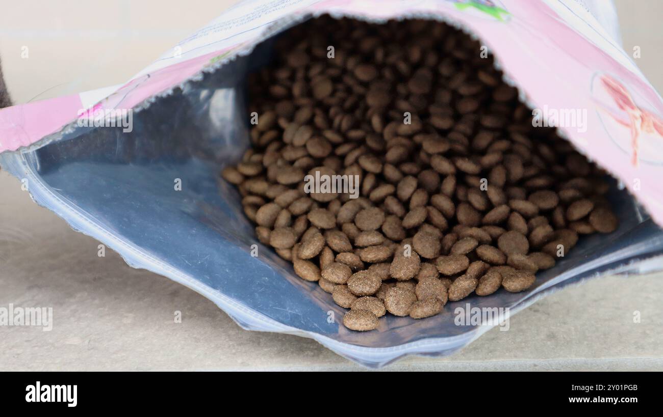 Pet food in a ziplock bag. Dry dog food spilled from the package Stock ...