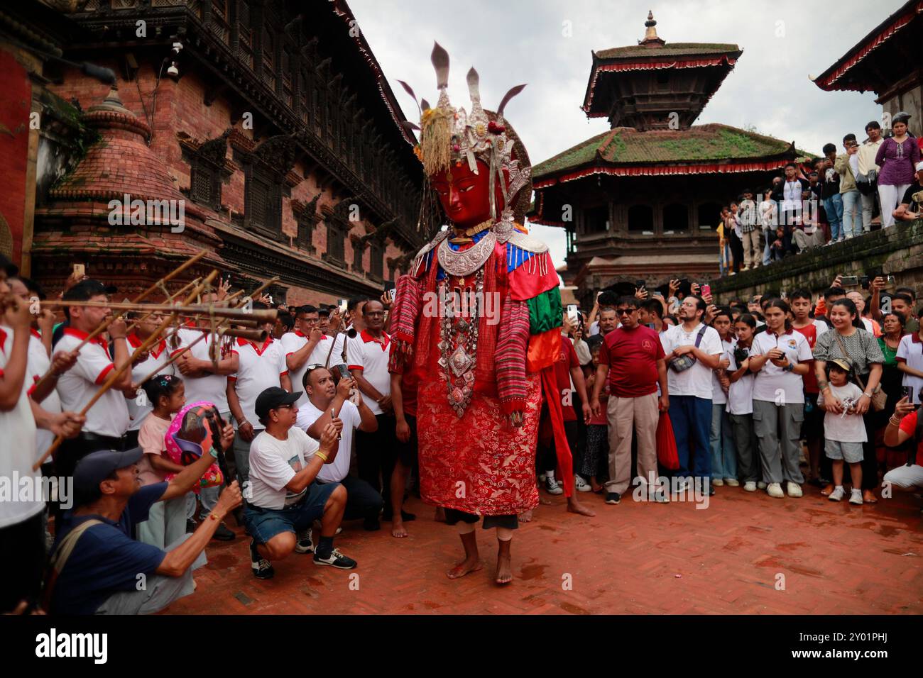 Devotees play traditional instruments as a person concealed inside the ...