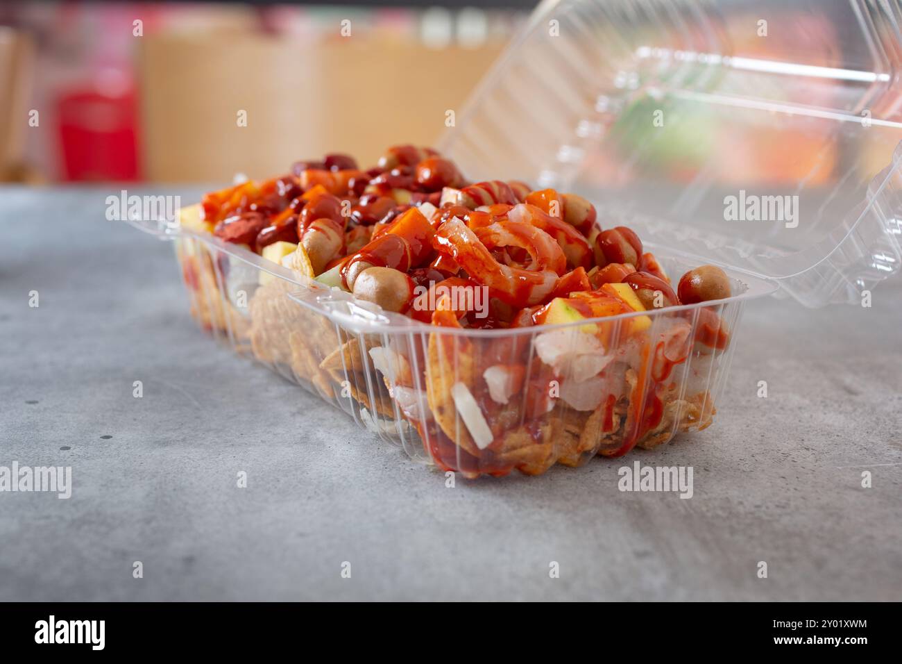 A view of a plastic container of tostilocos Stock Photo - Alamy