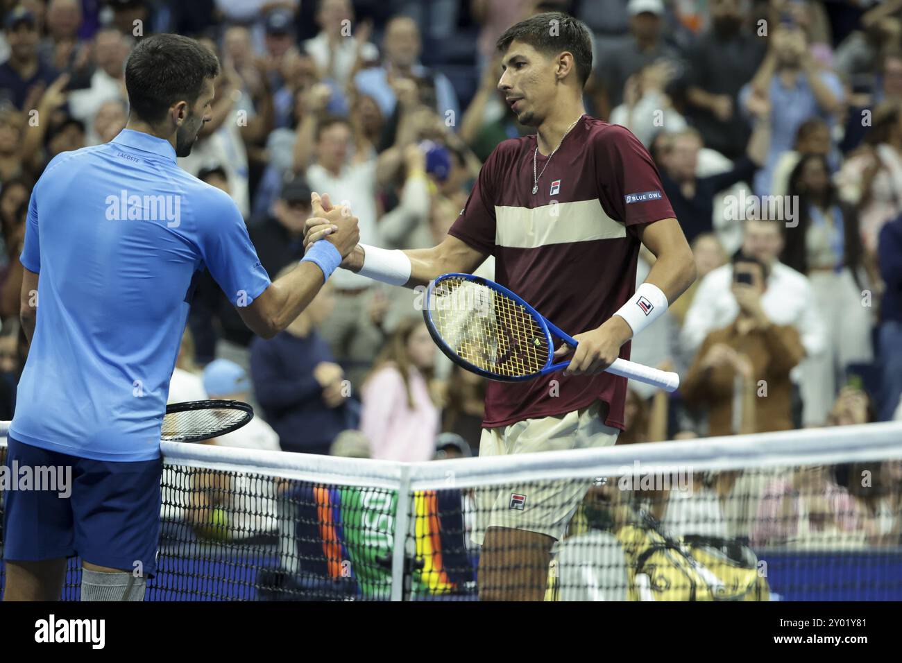 Alexei Popyrin of Australia (R) shakes hands with Novak Djokovic of Serbia after his third round ...