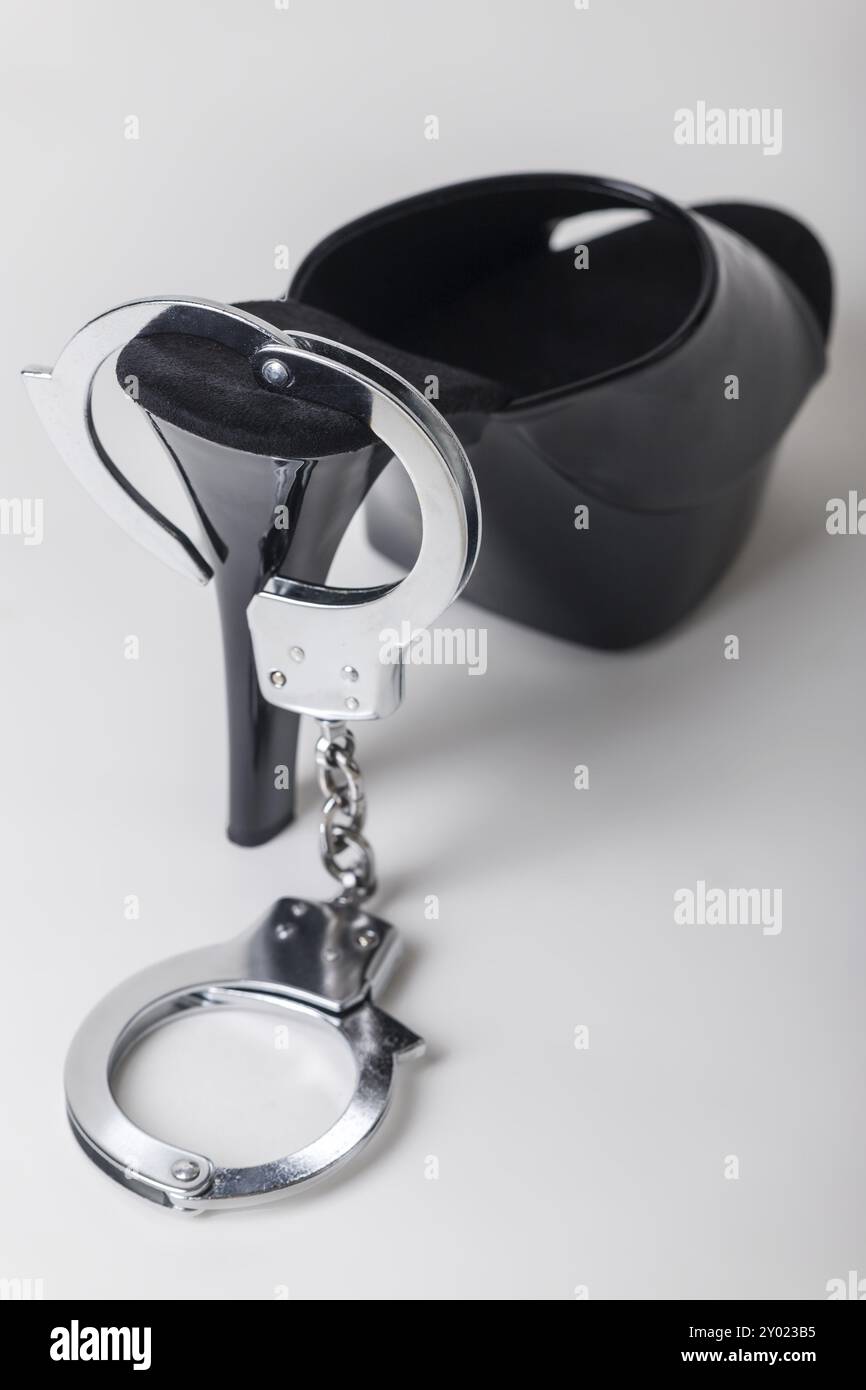 High heels and steel handcuffs Stock Photo - Alamy