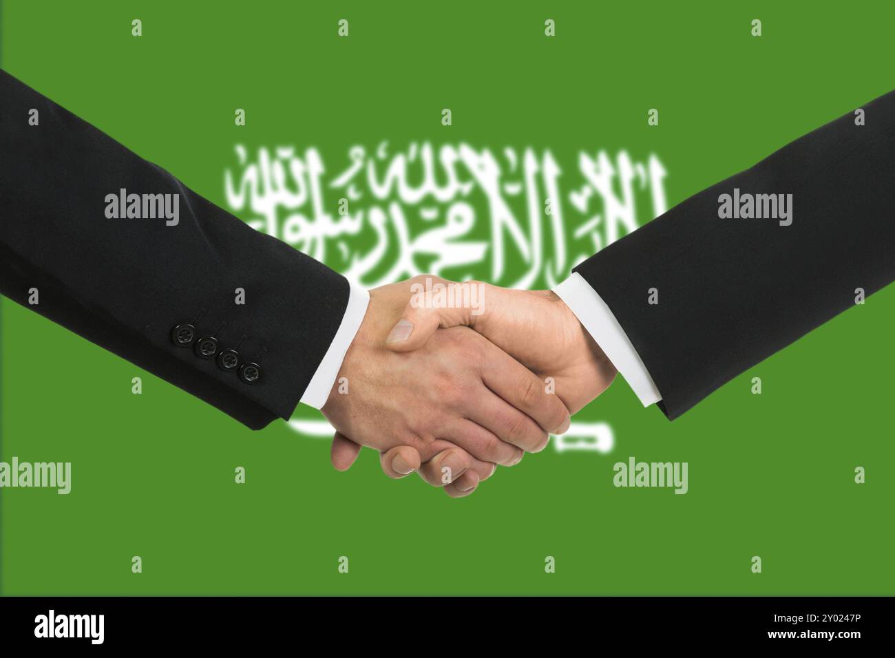 The Saudi Arabia flag and business handshake Stock Photo - Alamy