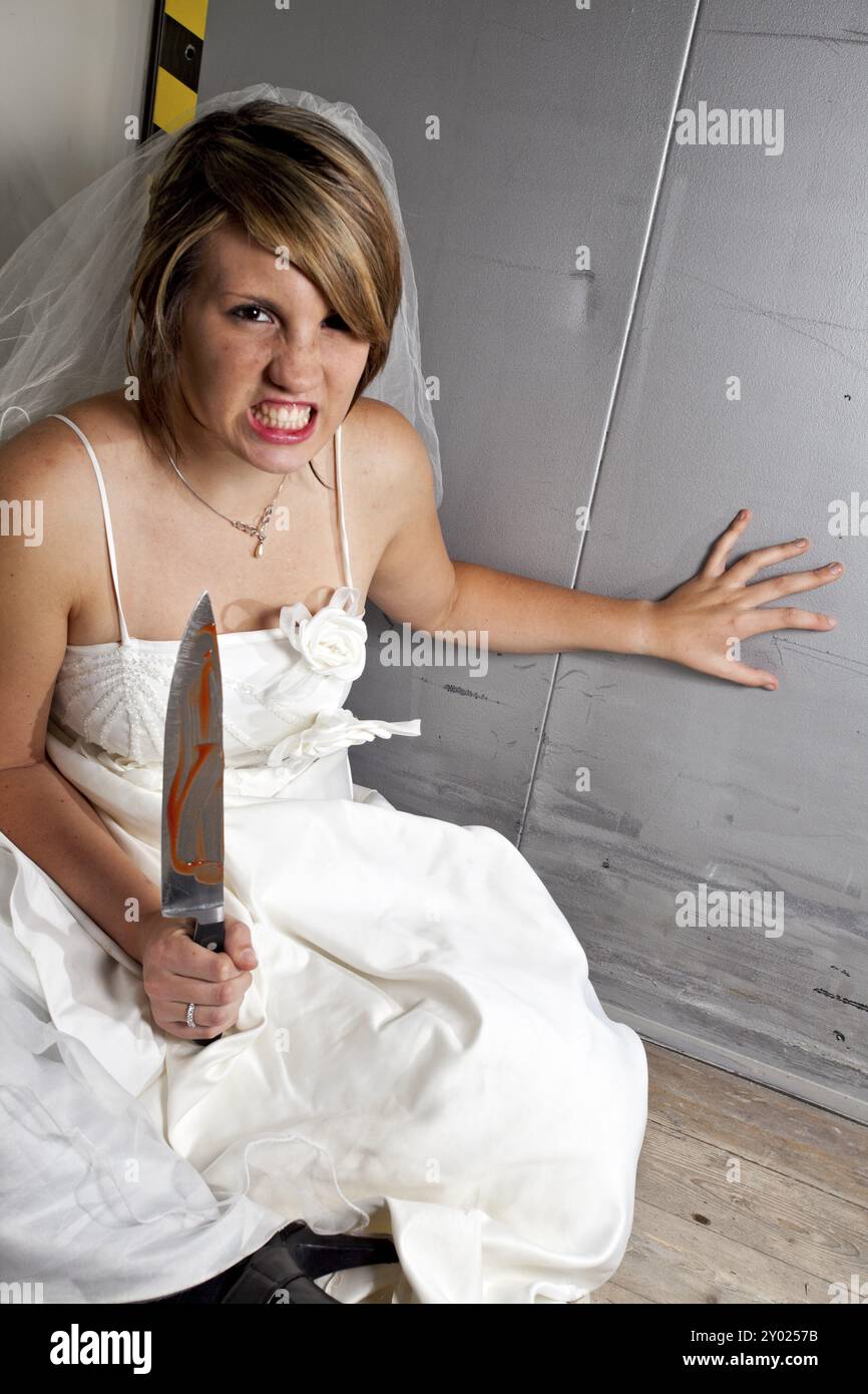 Angry young bride with a bloody knife in an elevator Stock Photo - Alamy