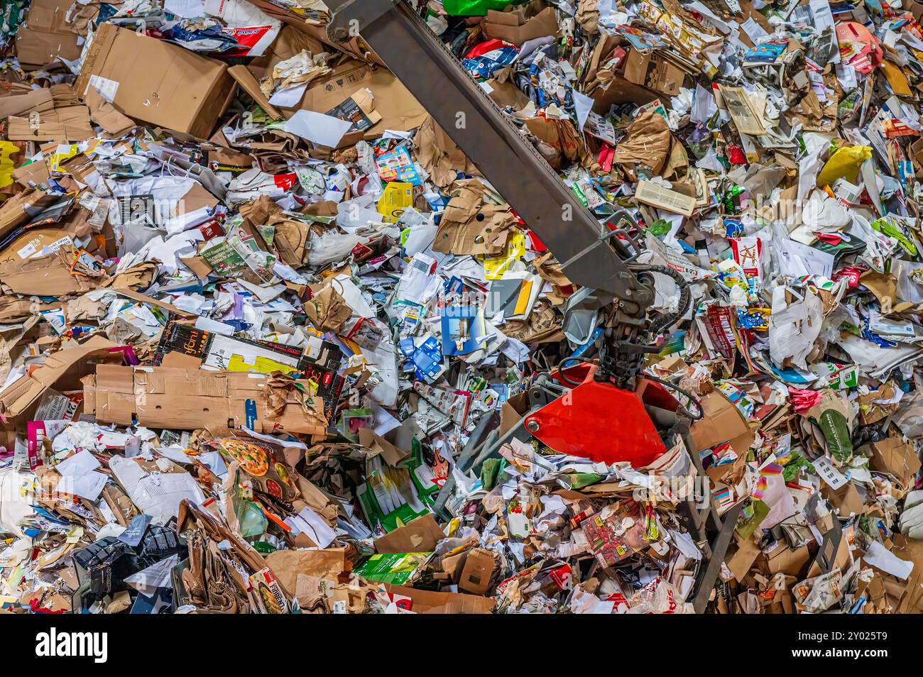 Red excavator working recycled waste in recycle factory in Switrzerland ...