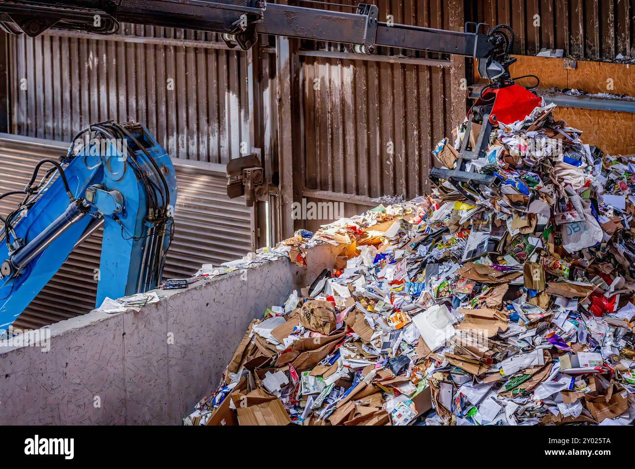 Red excavator working recycled waste in recycle factory in Switrzerland ...